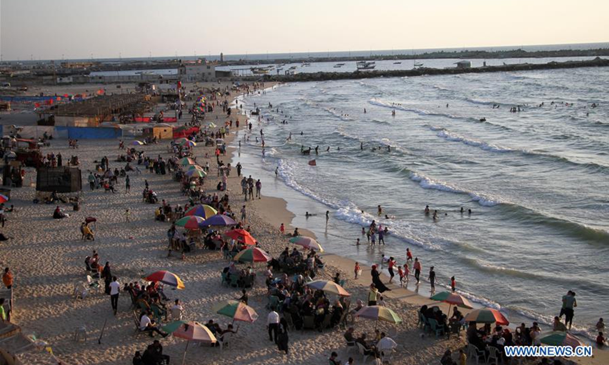 Palestinians enjoy their time during sunset at seaside in Gaza City ...