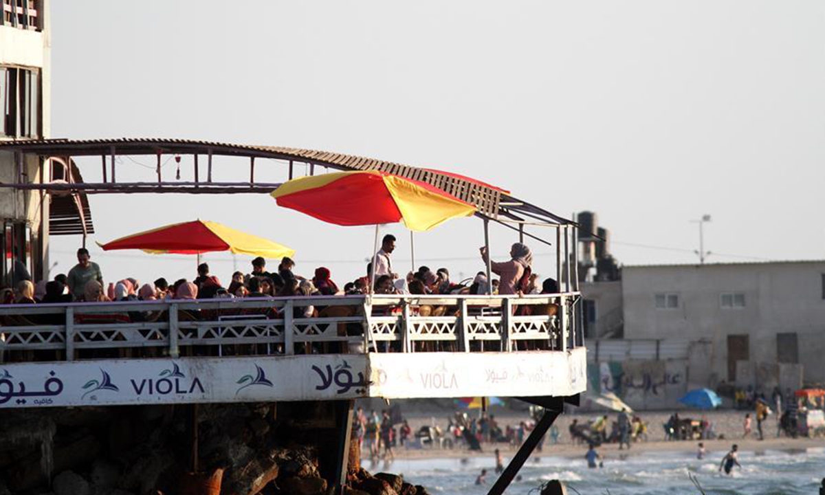 Palestinians enjoy their time during sunset at seaside in Gaza City ...