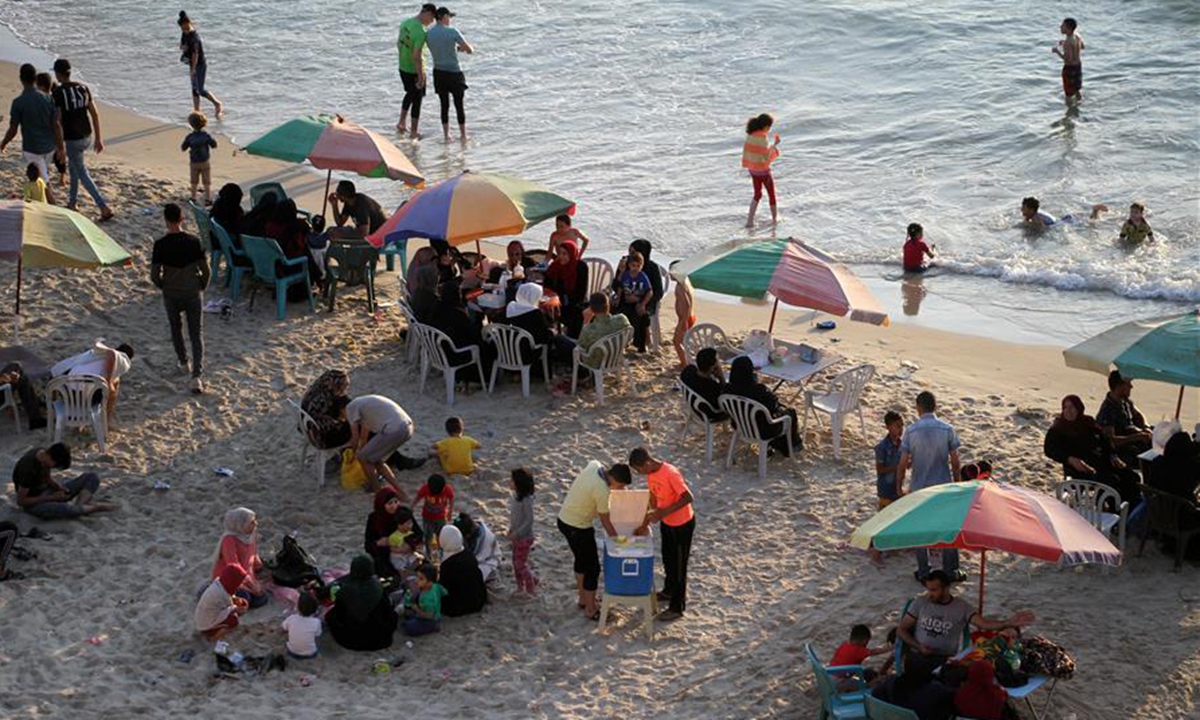 Palestinians enjoy their time during sunset at seaside in Gaza City ...
