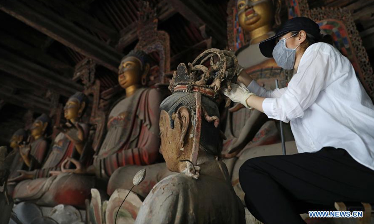 Relic conservation experts restore colour-painted clay sculptures at ...