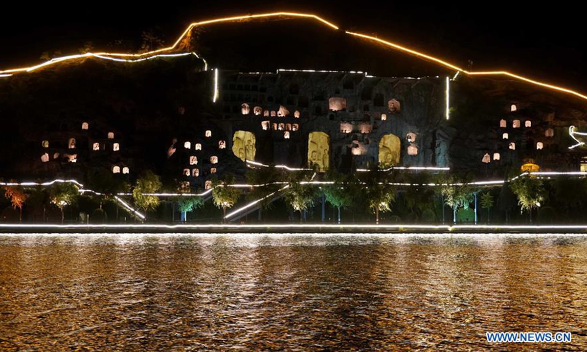 Tourists take part in night tour at Longmen Grottoes scenic area ...