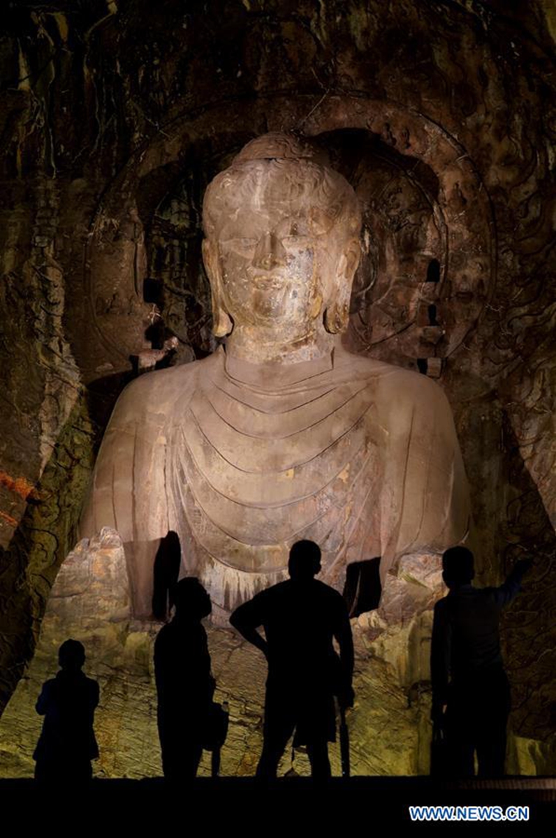 Tourists take part in night tour at Longmen Grottoes scenic area ...