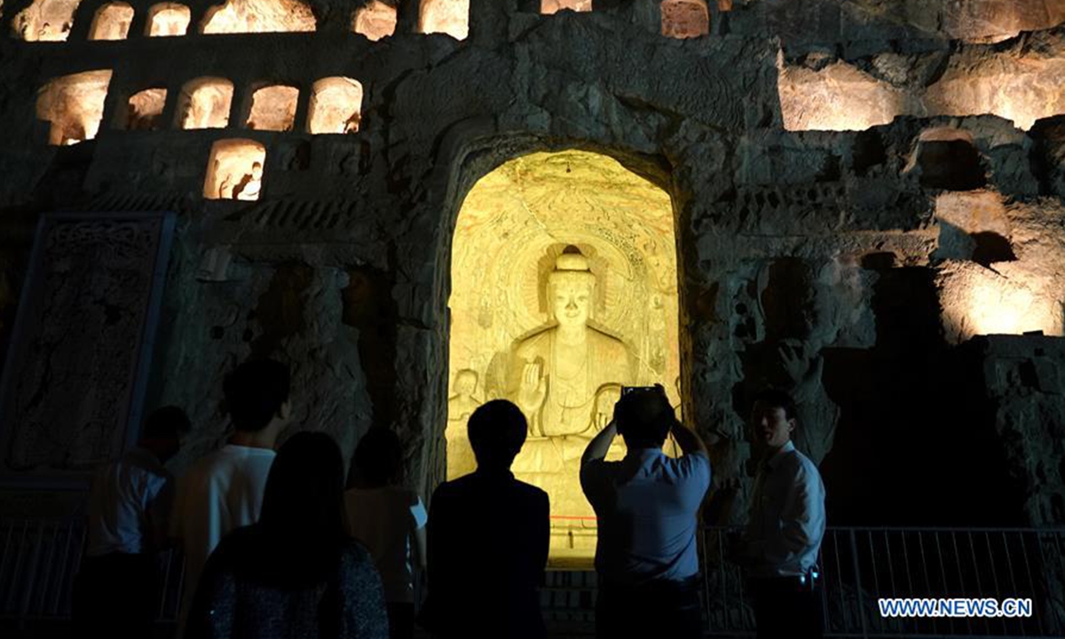 Tourists take part in night tour at Longmen Grottoes scenic area ...