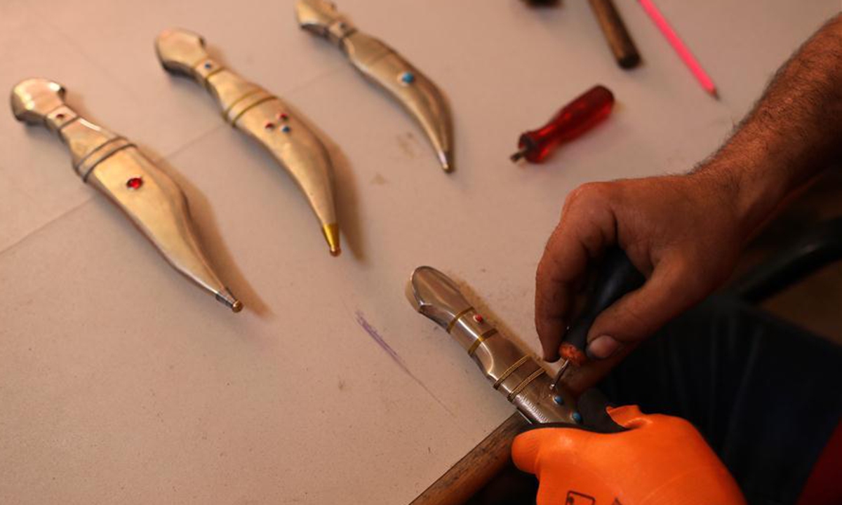 Palestinian craftsman makes traditional dagger at workshop in southern ...