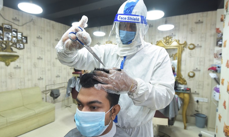 Bangladeshi barbers wearing PPE help quell customers' fears amid ...
