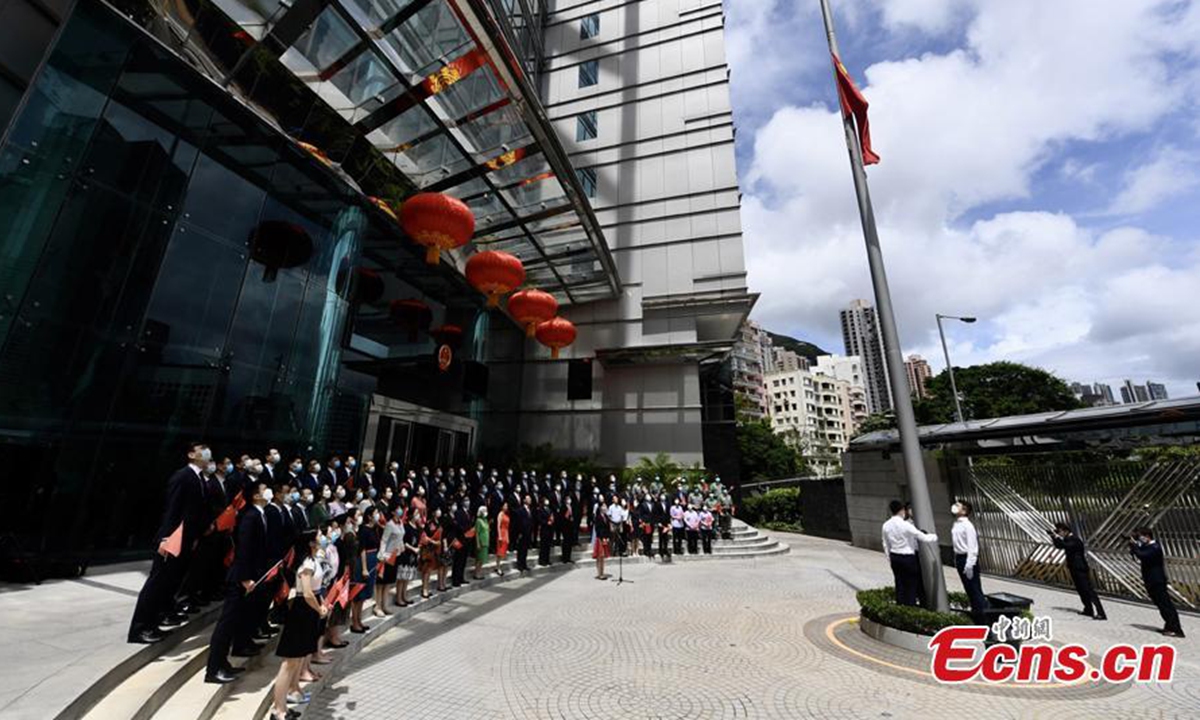 Commissioner's office of Chinese foreign ministry in HK holds flag ...