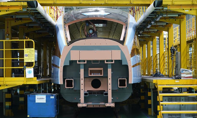Technicians work on high-speed trains production line in Tangshan ...
