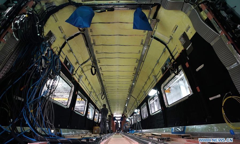 Technicians work on high-speed trains production line in Tangshan ...