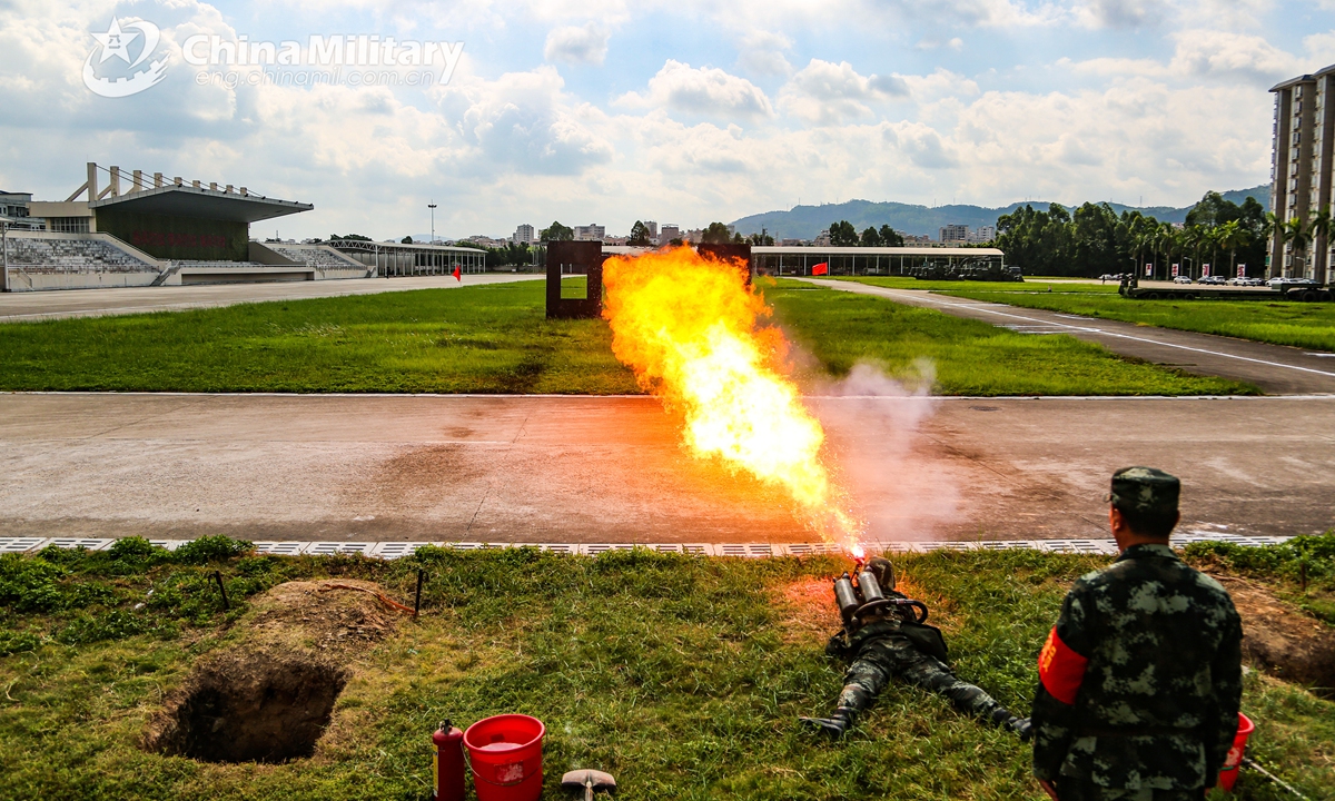 Flamethrower operators burn down mock targets - Global Times