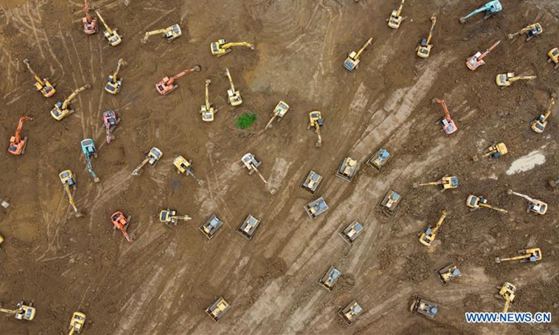 Heavy machineries work to build temporary embankment to prevent ...