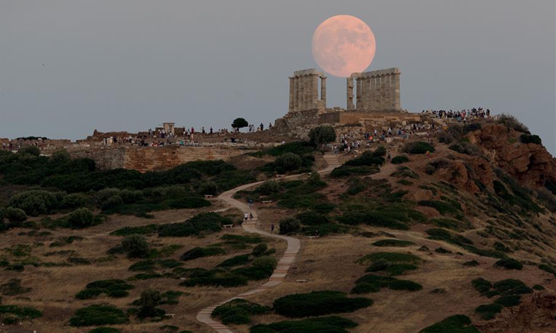 View of full moon rising over ancient Temple of Poseidon in Greece ...
