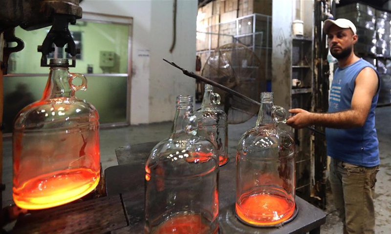 Workers make glassware at glass factory in Tripoli, Lebanon - Global Times