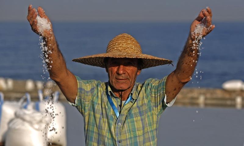 Lebanese workers practice traditional salt production technique ...