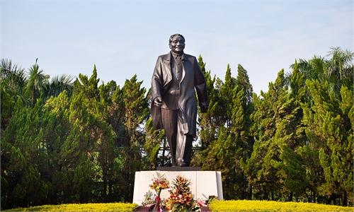President Xi presents a flower basket to former leader Deng Xiaoping at ...