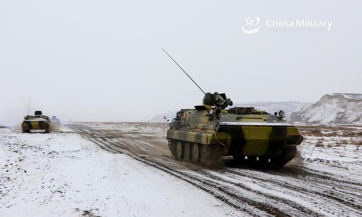 Armored vehicles rumble on snow-covered road - Global Times