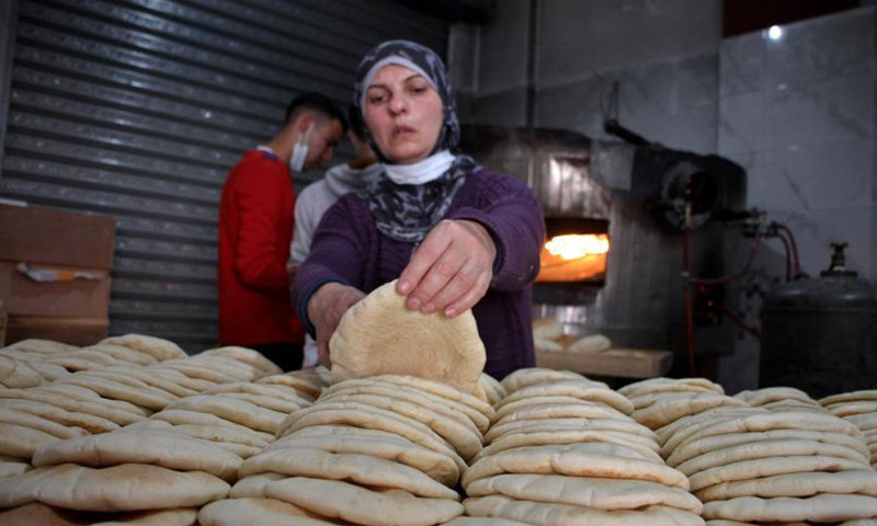 Palestinian woman works at bakery in Gaza city - Global Times