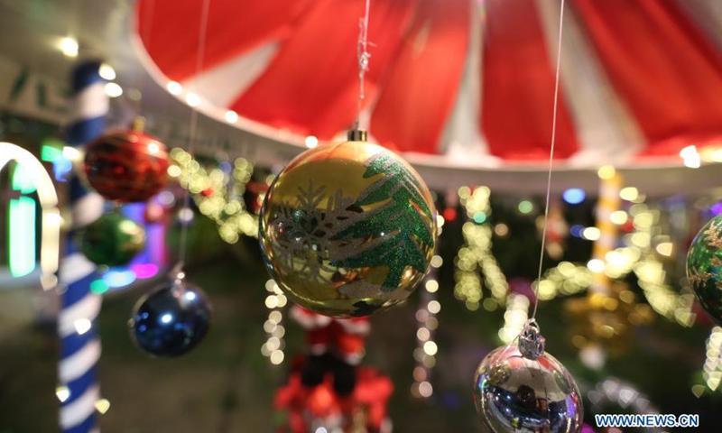 Visitors pose for photos with Christmas decorations in Yangon, Myanmar ...