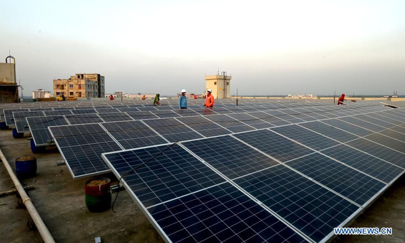Supervisors monitor installation process of solar panels on factory ...