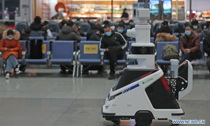 Disinfection, temperature-checking robot works at railway station in NE ...