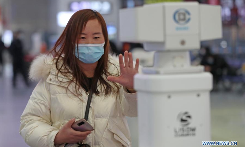Disinfection, temperature-checking robot works at railway station in NE ...