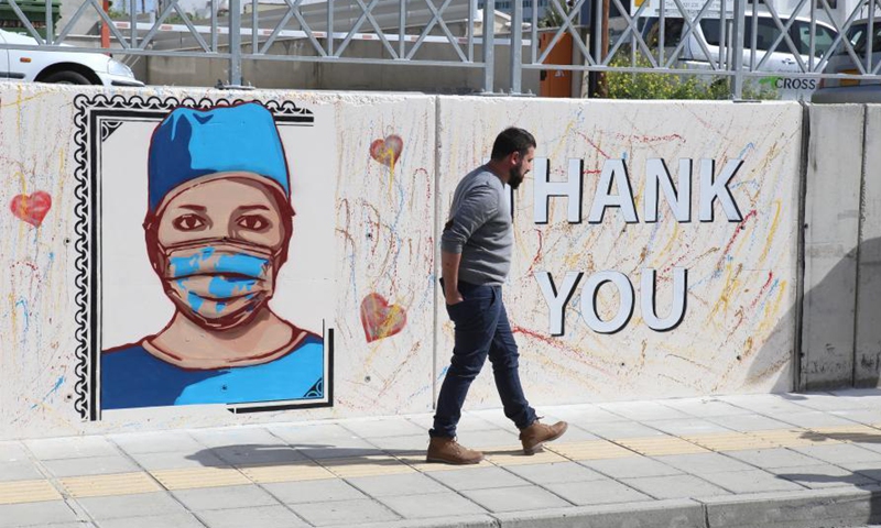 A mural paying tribute to health workers created by Cypriot artist seen ...