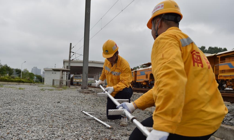 Railway staff members ensure safe operation of high-speed railway lines ...