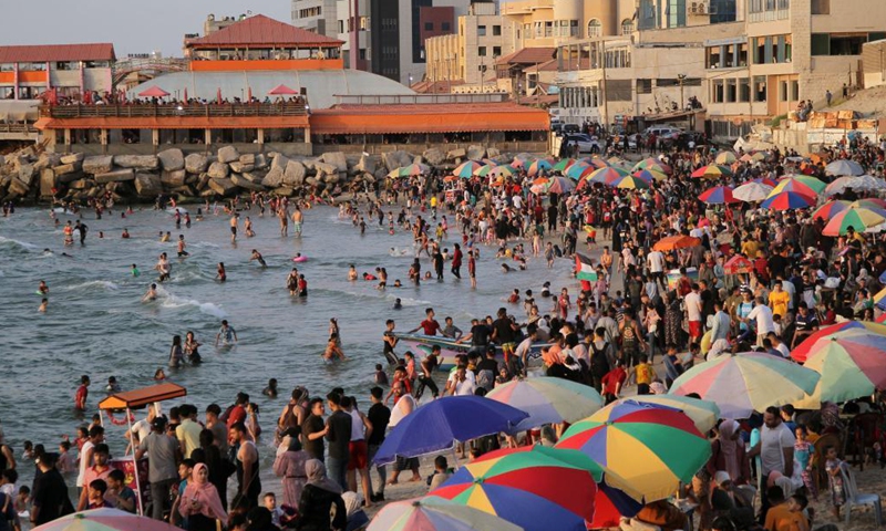 Palestinians enjoy themselves in Mediterranean Sea off Gaza coast ...