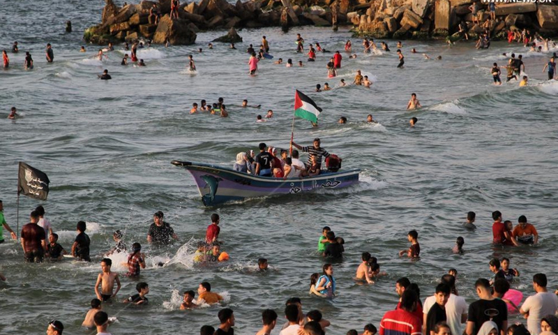 Palestinians enjoy themselves in Mediterranean Sea off Gaza coast ...