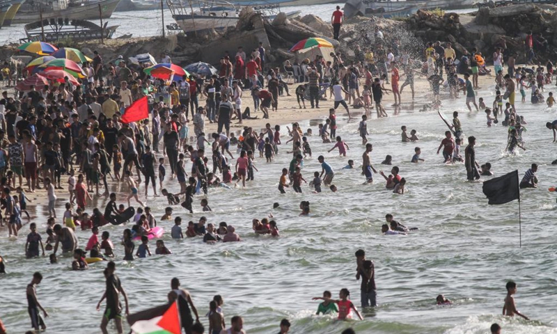 Palestinians enjoy themselves in Mediterranean Sea off Gaza coast ...