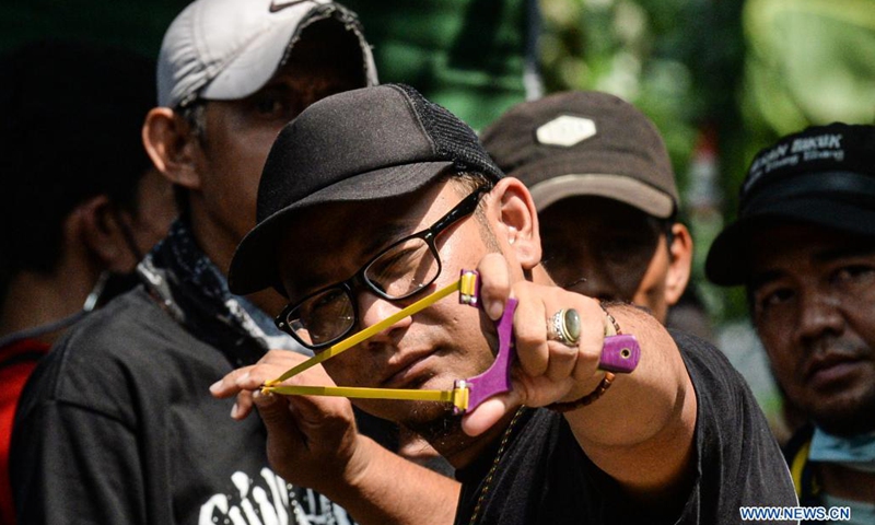 People participate in traditional slingshot regional competition in ...