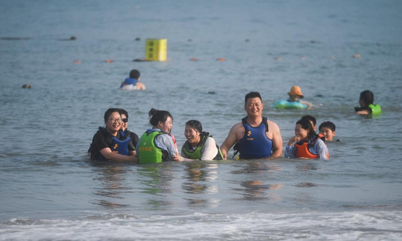 Tourists enjoy seaside time at Nansha beach resort in Zhoushan, E China ...