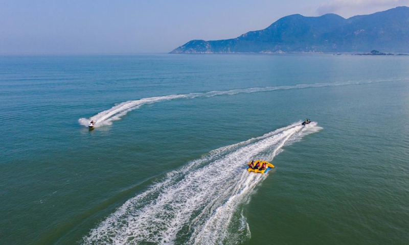 Tourists enjoy seaside time at Nansha beach resort in Zhoushan, E China ...
