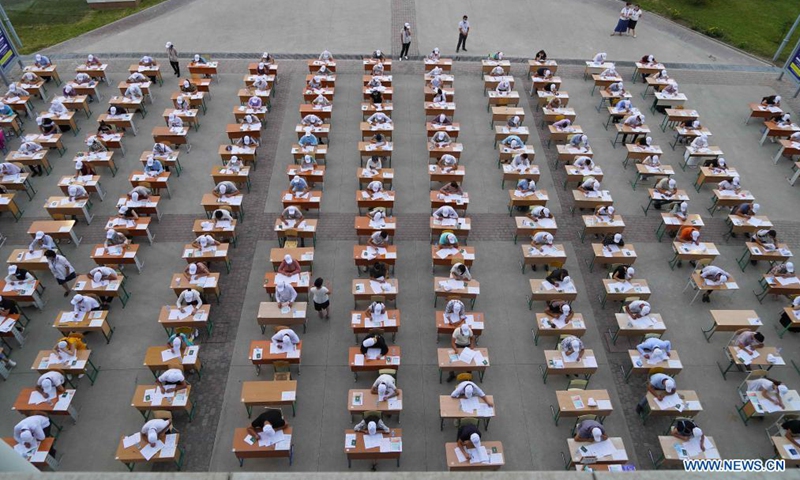 Students attend university entrance examination at outdoor exam site in ...