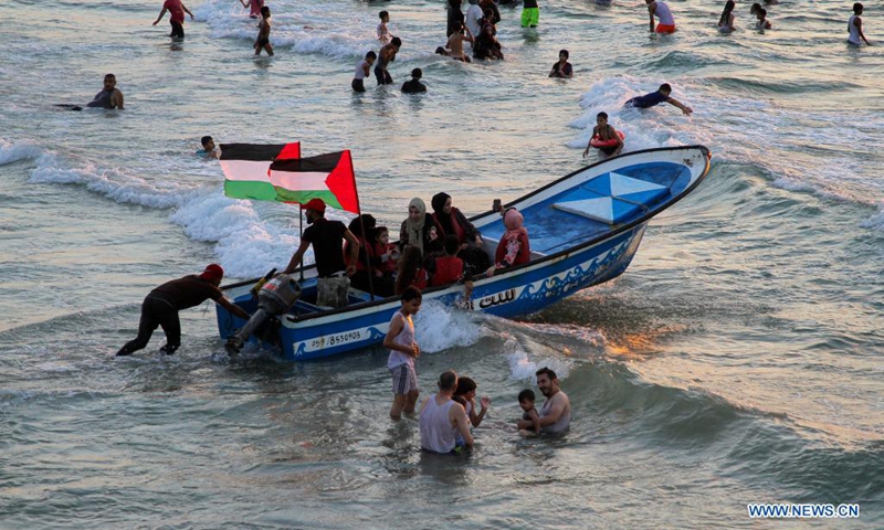 Palestinians enjoy themsleves at sunset in Mediterranean Sea off Gaza ...