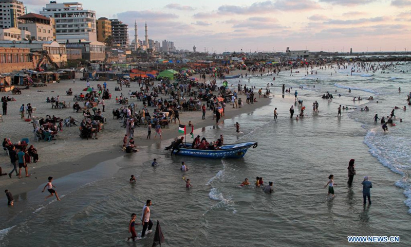 Palestinians enjoy themsleves at sunset in Mediterranean Sea off Gaza ...