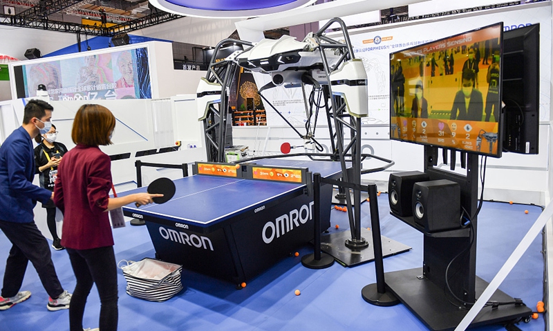 AI-equipped table tennis robot coach provides training for visitors at ...