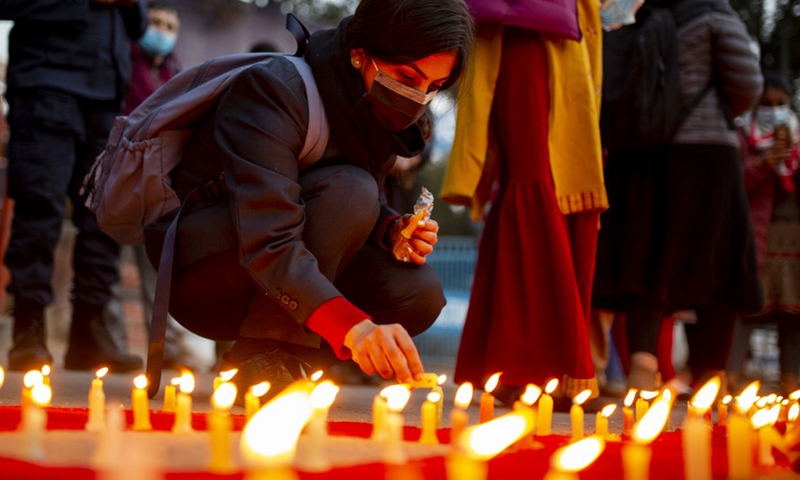 Nepali volunteers light candles during awareness campaign on eve of ...