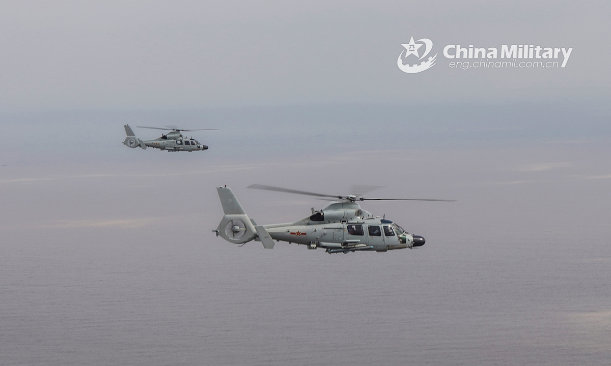 Ship-borne helicopters fly above sea - Global Times