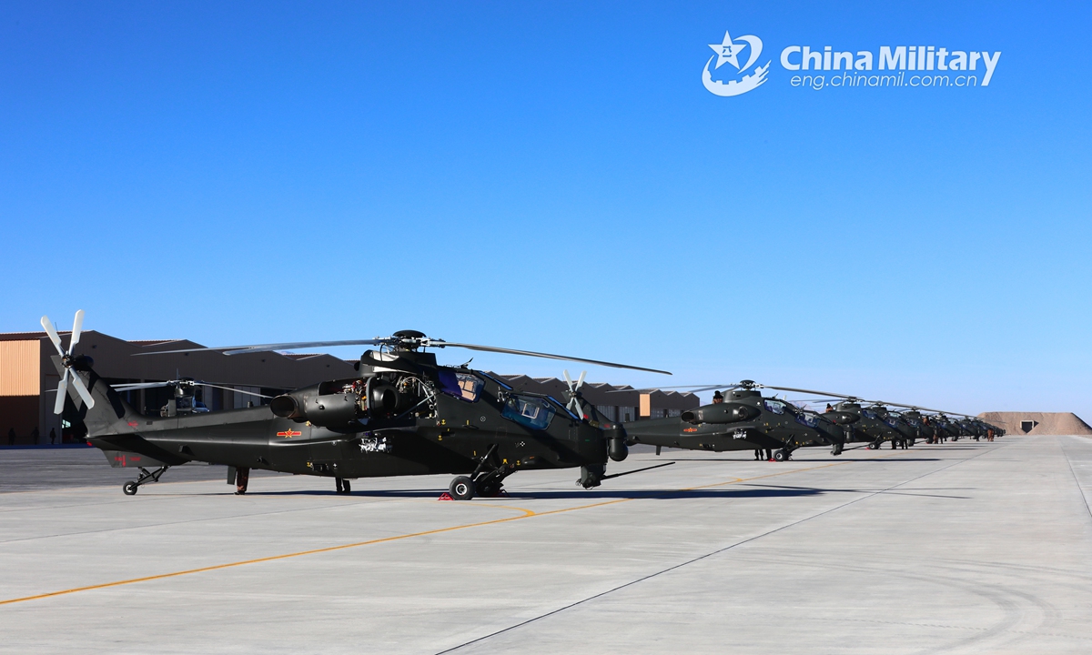Helicopters sit abreast on flightline before lift off - Global Times