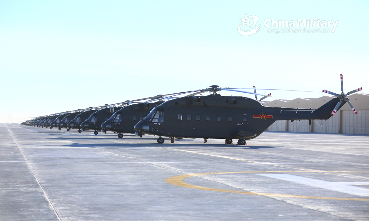 Helicopters sit abreast on flightline before lift off - Global Times