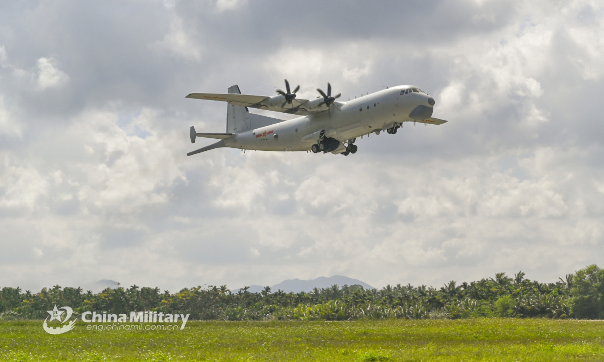 Maintenance men perform examination on anti-submarine patrol aircraft ...