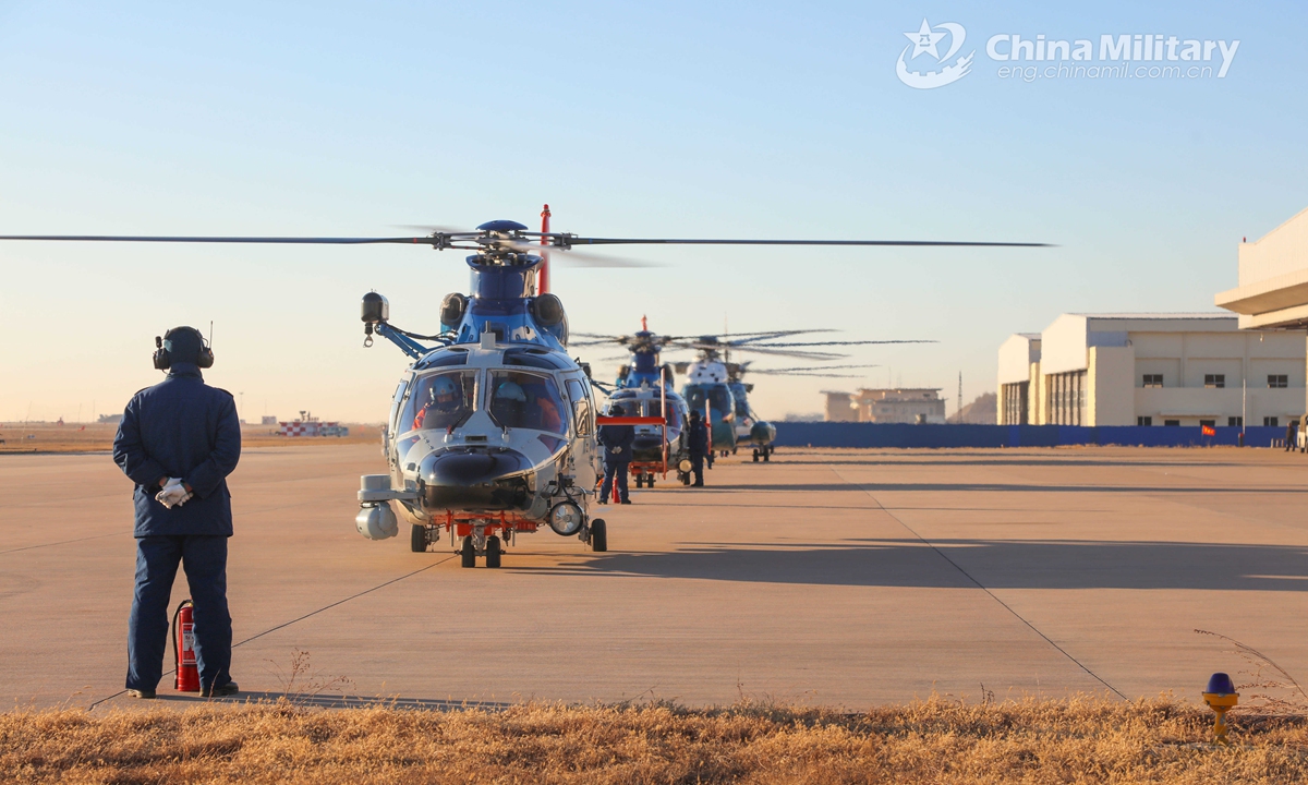 Naval ship-borne helicopters practice maritime rescue operation ...