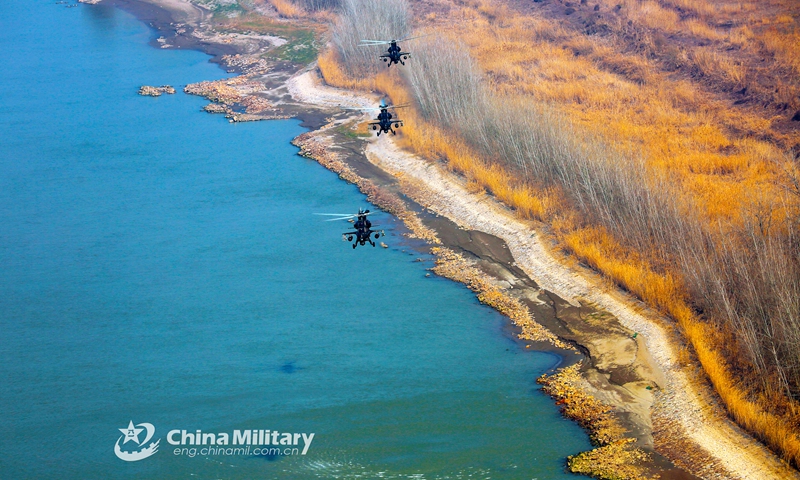 Attack helicopters fly over river bank - Global Times