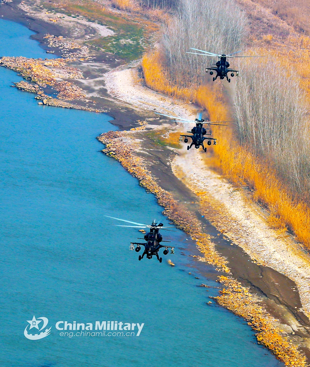 Attack helicopters fly over river bank - Global Times
