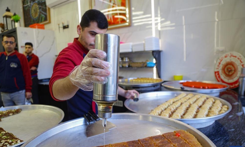 Staff members prepare traditional sweets during holy month of Ramadan ...