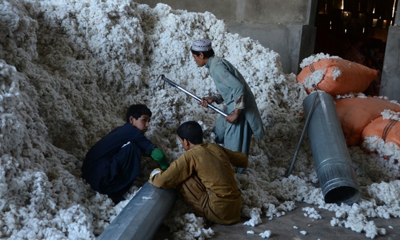 People work at cotton processing plant in Afghanistan's Kandahar ...