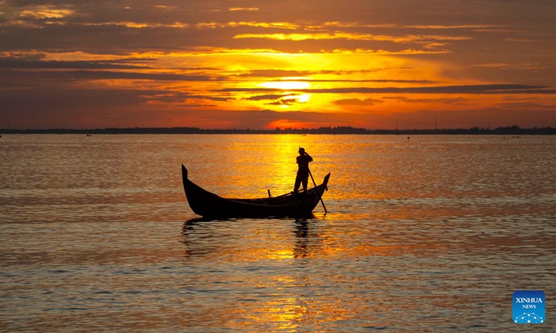 Fishermen catch fish at sunrise at Pusong Baru beach in Indonesia ...
