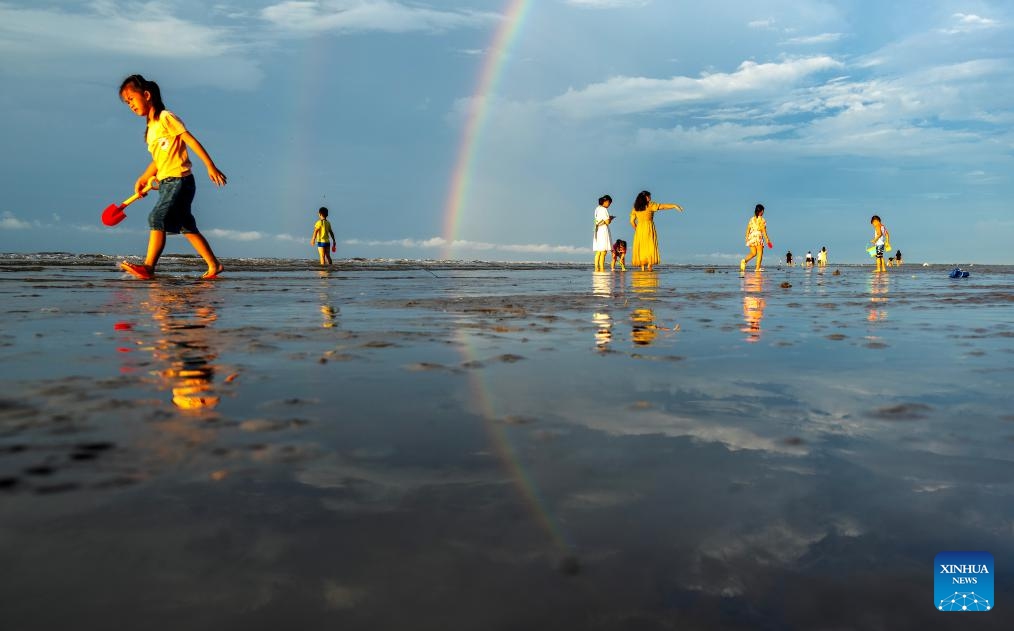Tourists have fun at Jintan beach in Dongxing, S China's Guangxi ...