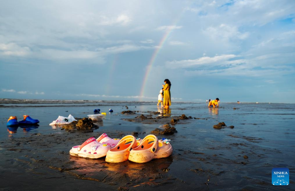 Tourists have fun at Jintan beach in Dongxing, S China's Guangxi ...