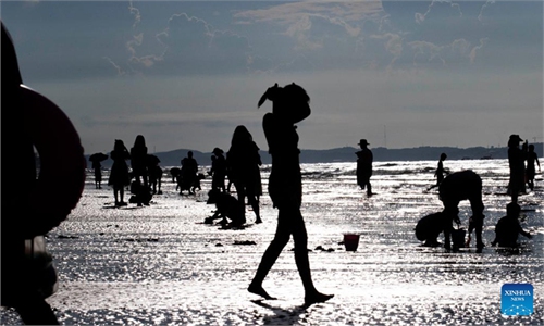 Tourists have fun at Jintan beach in Dongxing, S China's Guangxi ...